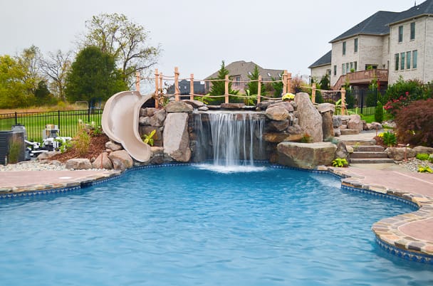 10 Pools With Slides Perfect For Summer - Homes of the Rich